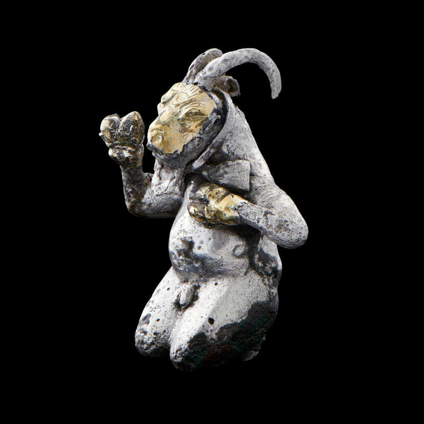A Proto-Elamite Silver Gilt Kneeling Goat-Headed Anthropomorphic Deity ...